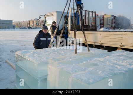 Two assembler workers store ice slabs at the construction site of the ...