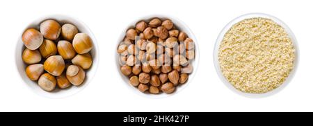 Hazelnuts in white bowls. Whole nuts, shelled, blanched and roughly ...