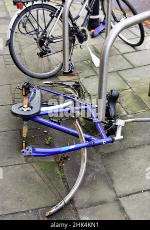 Vandalized bicycle stripped of most of its removable parts while locked ...