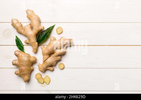 Finely dry Ginger powder in bowl with green leaves isolated on colored ...