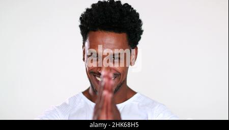 Grateful African man portrait giving thanks, faith gesture with hands ...