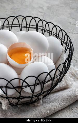 White Easter eggs in a mesh eco-bag with beautiful painted faces and a ...