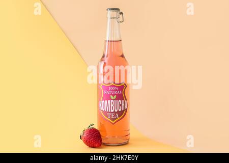Bottle of fresh strawberry kombucha on grunge background with space for ...