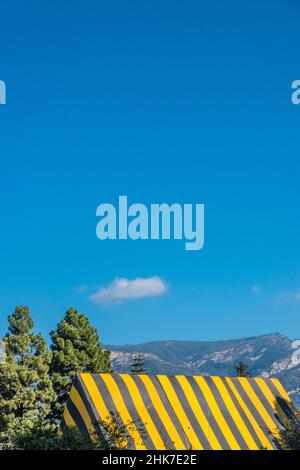 A tall A-frame roofed church that is tented for fumigation with a ...