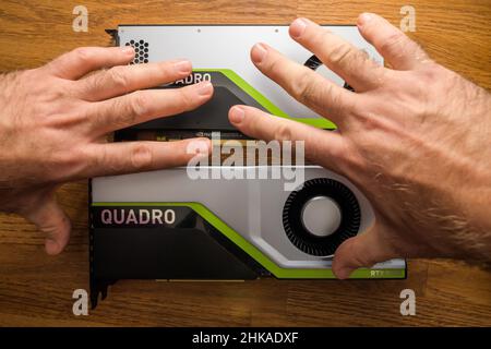 Senior engineer hands pov holding looking comparing two new GPU Nvidia ...