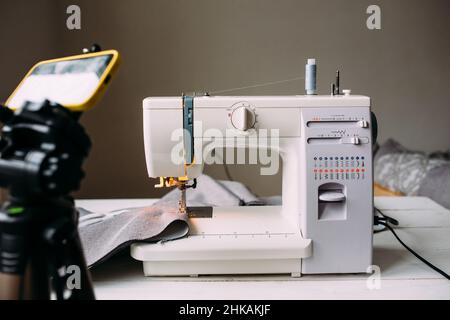 Shooting video of the sewing process, workshop on clothing design on ...