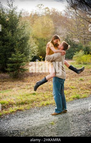 Young woman jumping into man's arms Stock Photo - Alamy