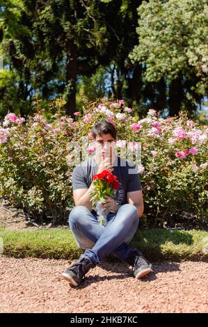 Hand holding a rose in the rose garden Stock Photo - Alamy