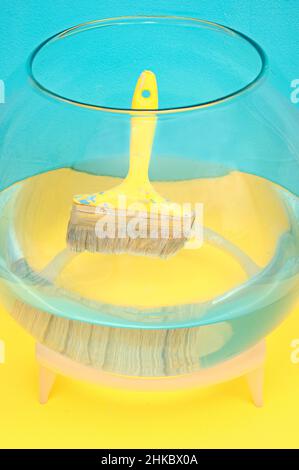 Water-based paint repair concept. yellow paint on artificial grass ...