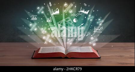 Open book with profit icons above Stock Photo - Alamy