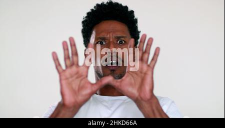 African man reacting with terror and horror to camera, black guy shock reaction Stock Photo - Alamy
