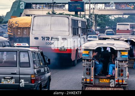 Exhaust smoke and fumes from bus in traffic on road in Manila ...