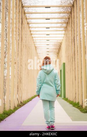 Caucasian woman in oversized red knitted jumper travels in motorhome in ...