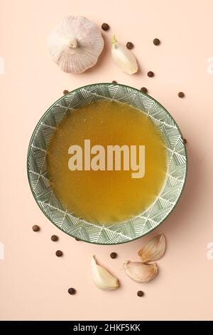 Concept of tasty food with broth on beige background Stock Photo - Alamy