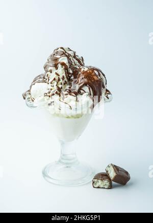 Yellow ice cream container with red cap and bar code against blue over ...