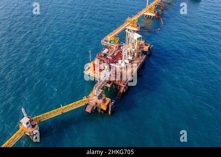 Aerial view of an oil well drilling platform on the tundra at the edge ...