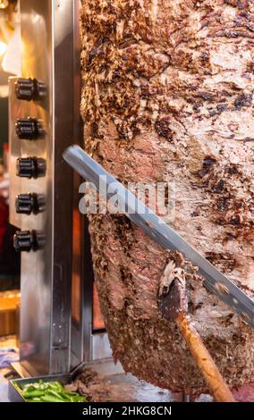 Gyros cutting with knife on fast food Stock Photo - Alamy