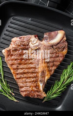 fried sliced porterhouse steak, t-bone steak on a plate with steak ...
