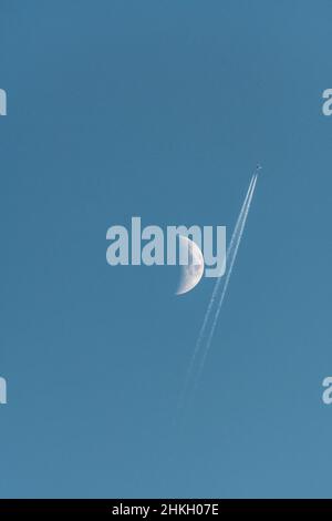 Plane passing near the moon Stock Photo - Alamy