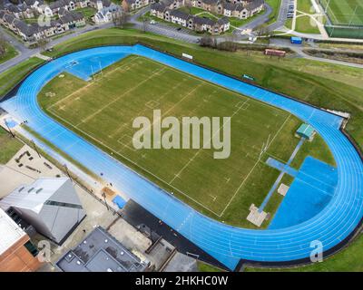 green grass around sport stadium aside running track with fence Stock ...