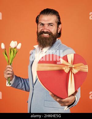 boxing day. formal party dress code. bearded hipster hold tulip flower ...