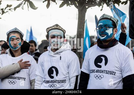 Protesters with Uyghur flag symbols painted in their faces during the ...