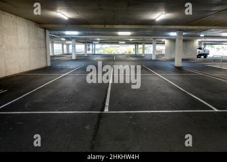 Inside & empty vacant parking bays in underground multi storey / level ...