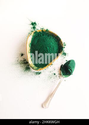 Spoon with spirulina powder on white background Stock Photo - Alamy