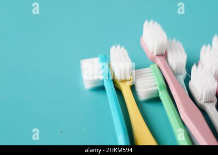 colorful toothbrushes on light green background with copy space Stock ...