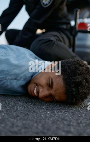 Police officer arresting suspicious young car driver Stock Photo - Alamy
