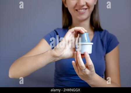 Girl showing her flash glucose monitor with normal blood sugar level ...