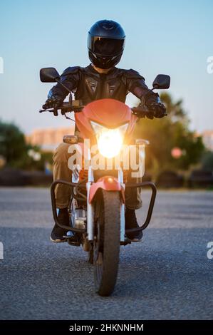 Male student poses on motorbike, motorcycle school Stock Photo - Alamy