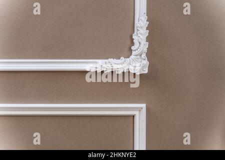 The panel is a plaster frame with patterned corners on the wall of the ...