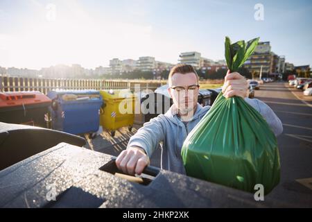 Garbage bag on a city street Stock Photo - Alamy