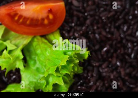 Black rice risotto with tomato. As a whole background Stock Photo - Alamy