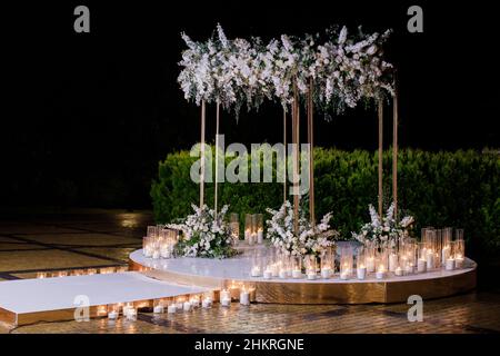 Night wedding ceremony with a lot of lights, candles, lanterns ...