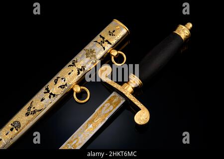 souvenir collectible silver gold dagger with scabbard on black. Luxury ...