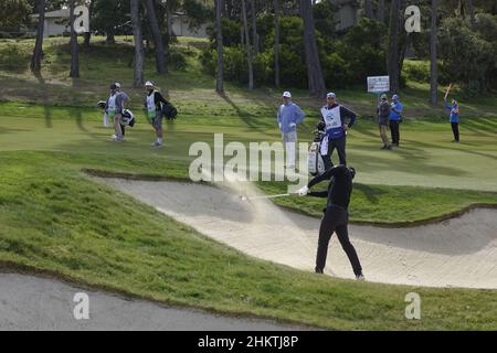 Min Woo Lee plays out of the bunker on the 3rd hole during the first ...
