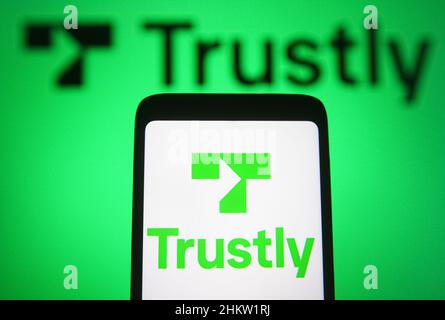 In this photo illustration, the Trustly logo is seen displayed on a ...