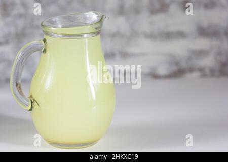 Liquid whey that remains after formation of curds in jar on the white ...