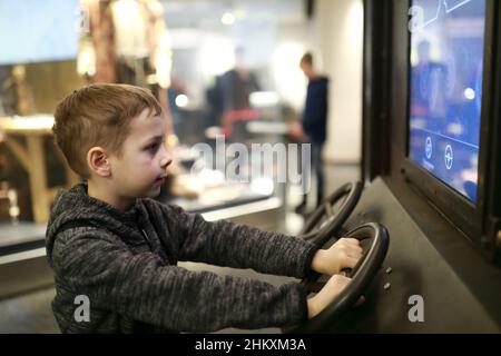 Portrait of kid playing racing simulator game Stock Photo - Alamy