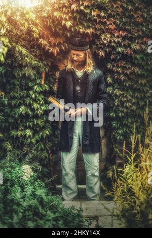 Alchemist in a beautiful ornamental dress in nature Stock Photo - Alamy