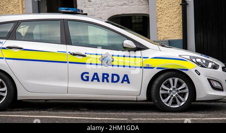 Garda, description on police car, with yellow and blue stripes on sides ...