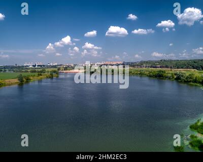 Wide river flowing between fields Stock Photo - Alamy