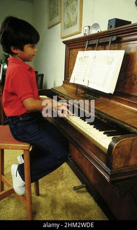 photo of boy with piano Stock Photo - Alamy