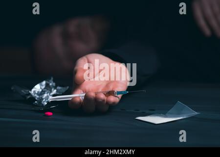 Drug addict reaches for another dose of drug. Concept of addiction ...