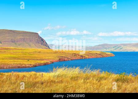Steppe plain on the background of Mount Tepsey under a blue cloudy sky. Siberia, Russia Stock ...