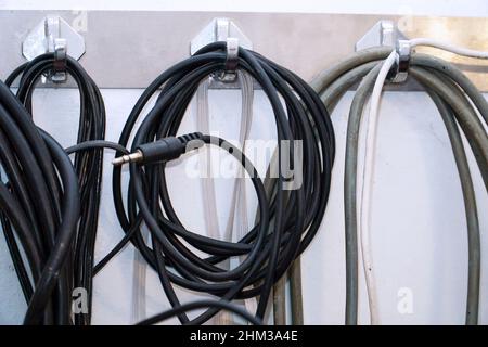 Coiled audio cables hang on the wall in the studio Stock Photo - Alamy