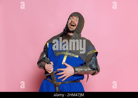 Portrait of laughing man, medieval warrior or knight in armor with ...