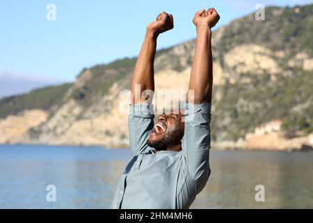 Black man celebrating success raising fist in the air. Successful ...